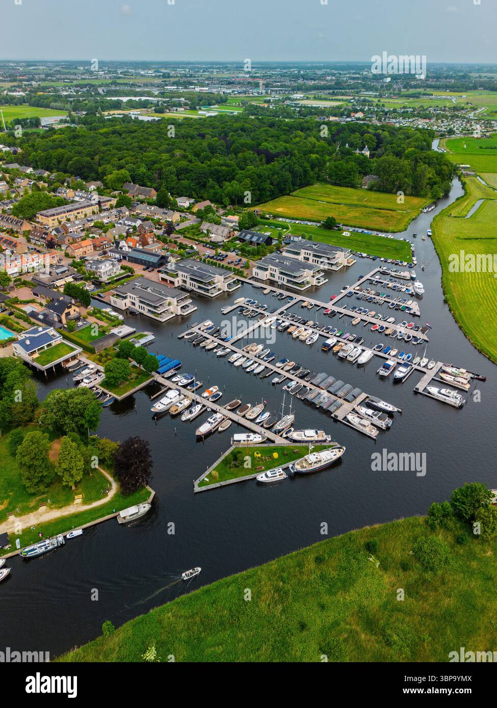 A top-down view of a marina with multiple boats docked along wooden ...