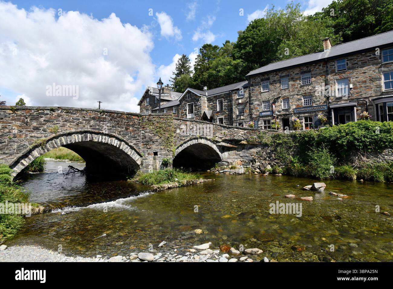 Old stone bridge on Afon Colwyn in the Welsh village of Beddgelert in ...
