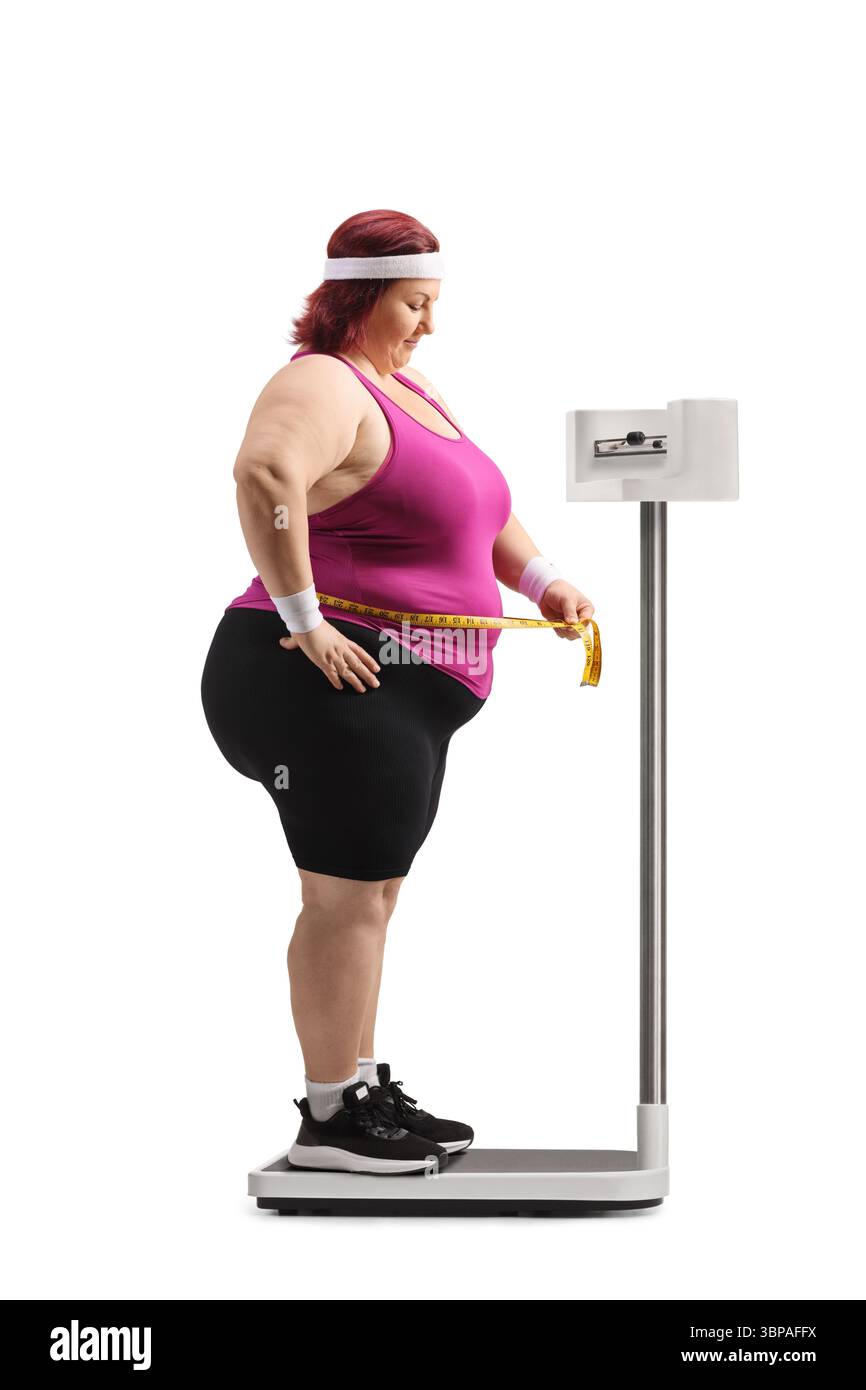 Woman measuring body mass on a scale isolated on white background Stock ...
