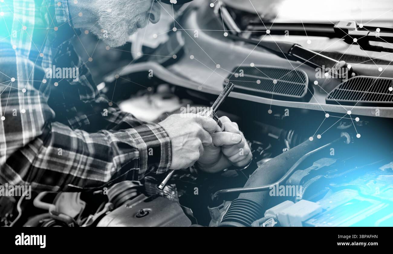 Car mechanic repairing a car engine; light effect Stock Photo - Alamy