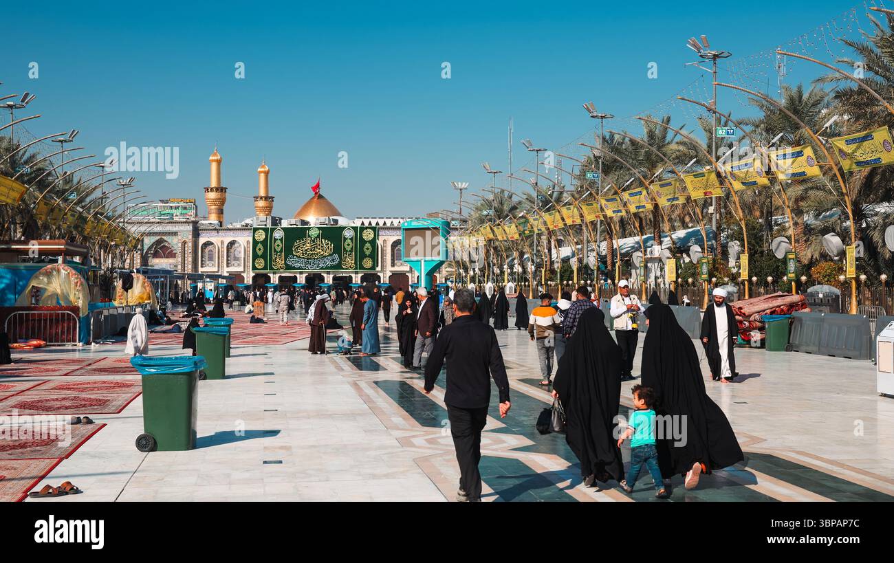 Visitors stroll through the sacred area in Karbala Iraq, surrounded by ...