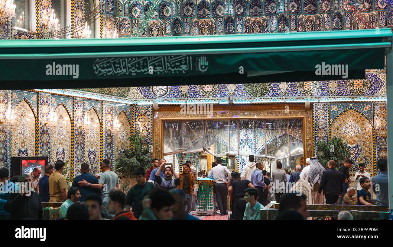 Visitors interact at the Imam Hussein Shrine in Karbala, Iraq as night ...