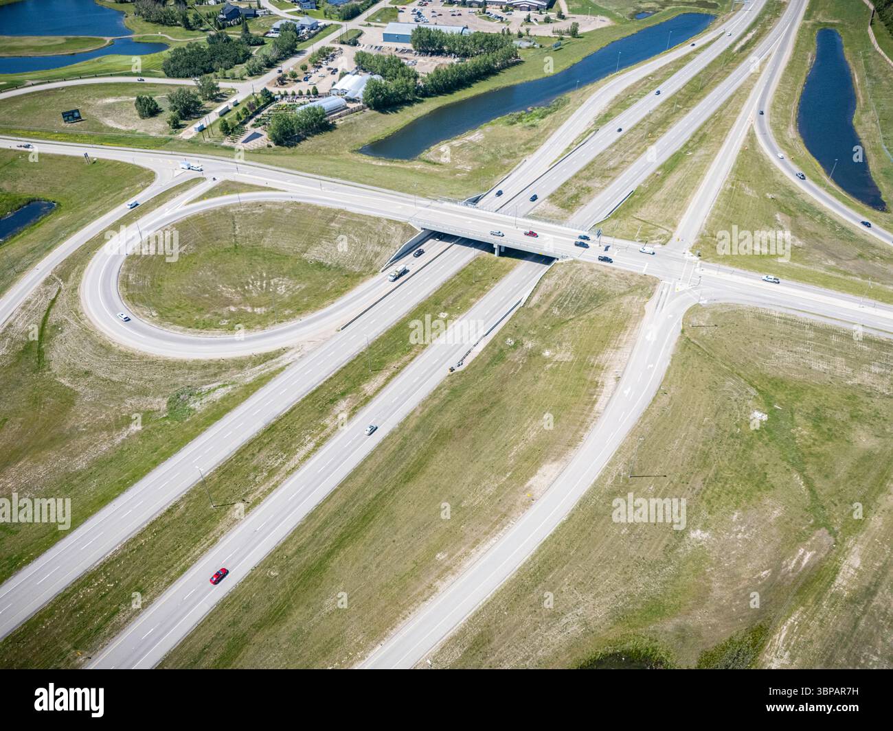 Highway with a lot of cars and a bridge in the middle. The road is very ...