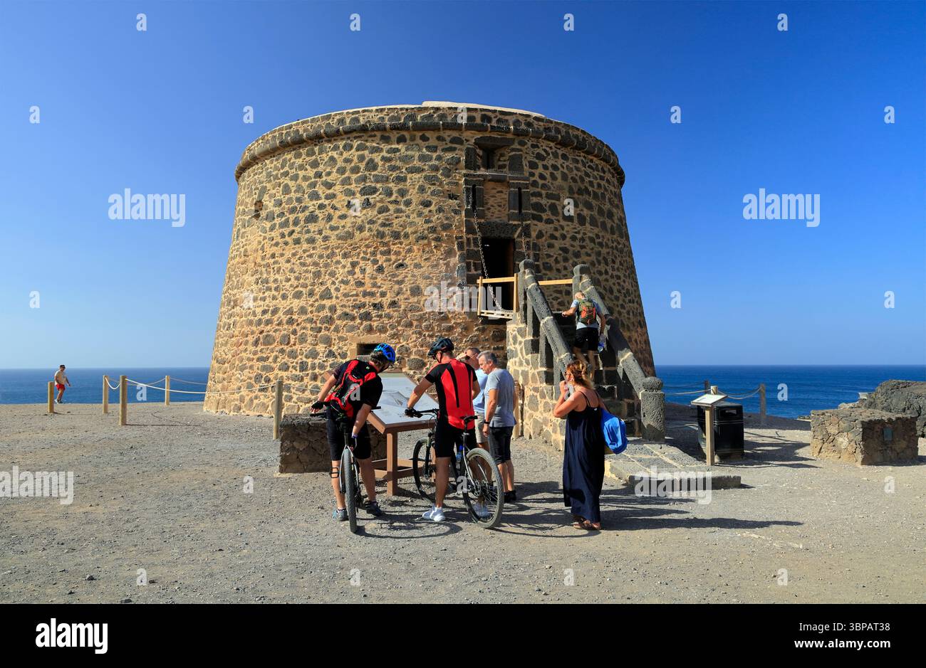 Cyclists and sightseers at Torre del Toston fortified tower at El ...