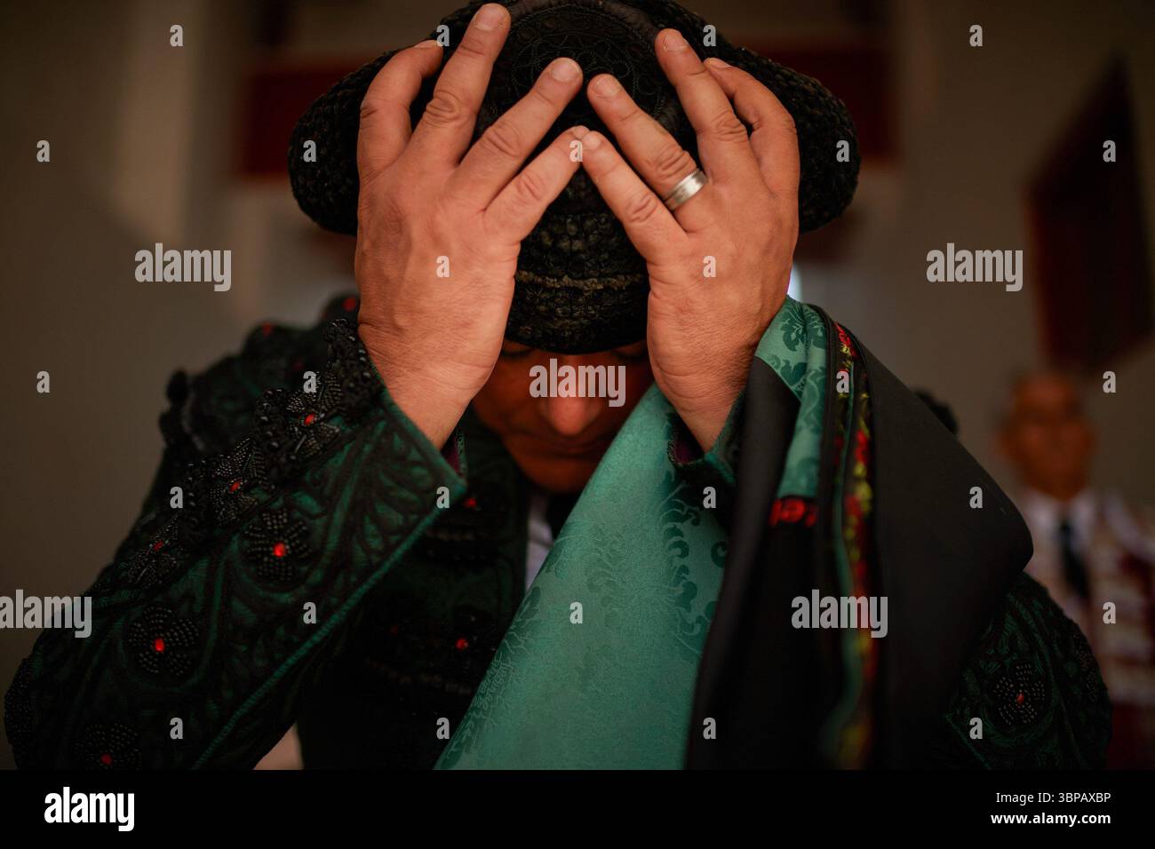 A banderillero from the bullfighters' team prepares by putting on his ...