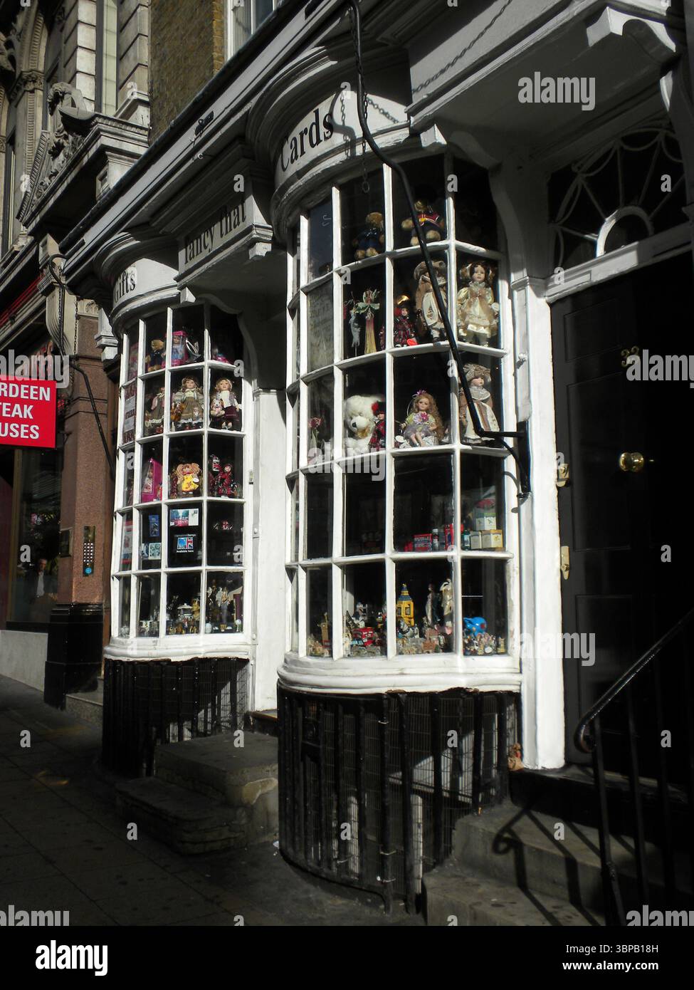 Vintage toy and doll shop with curved display windows on a London ...