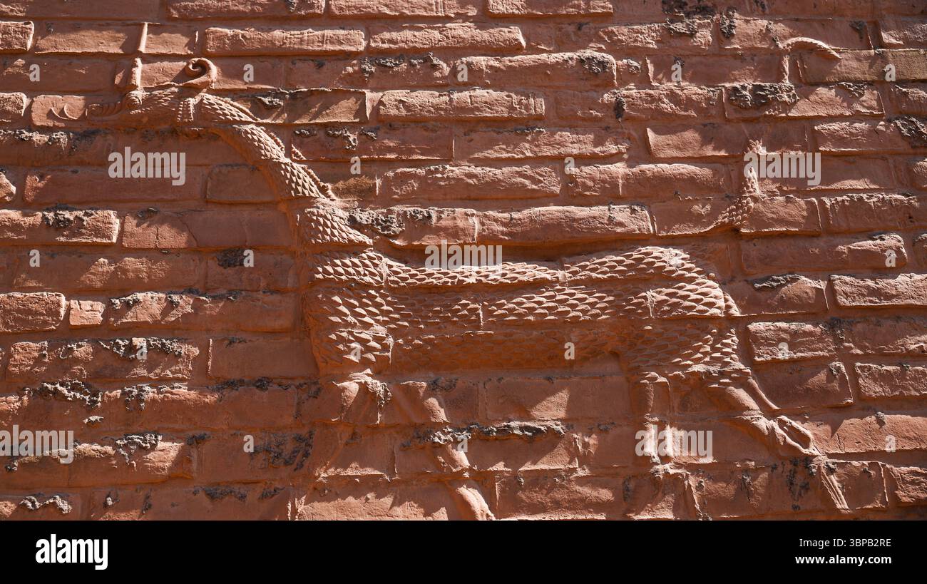 Detailed relief sculpture of a goat carved into a brick wall in ancient ...