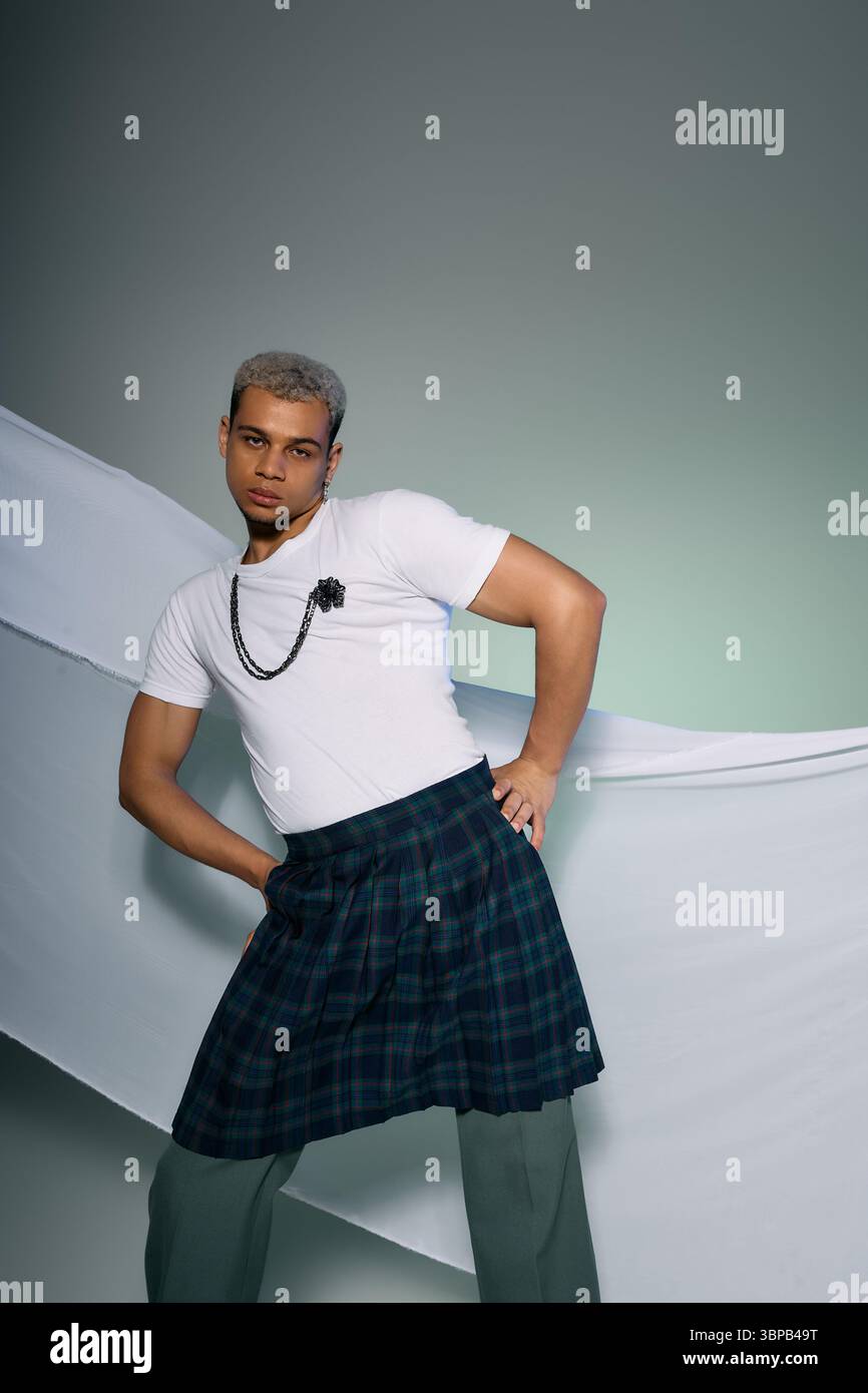 A stylish young Black man poses confidently in a chic outfit with dyed ...