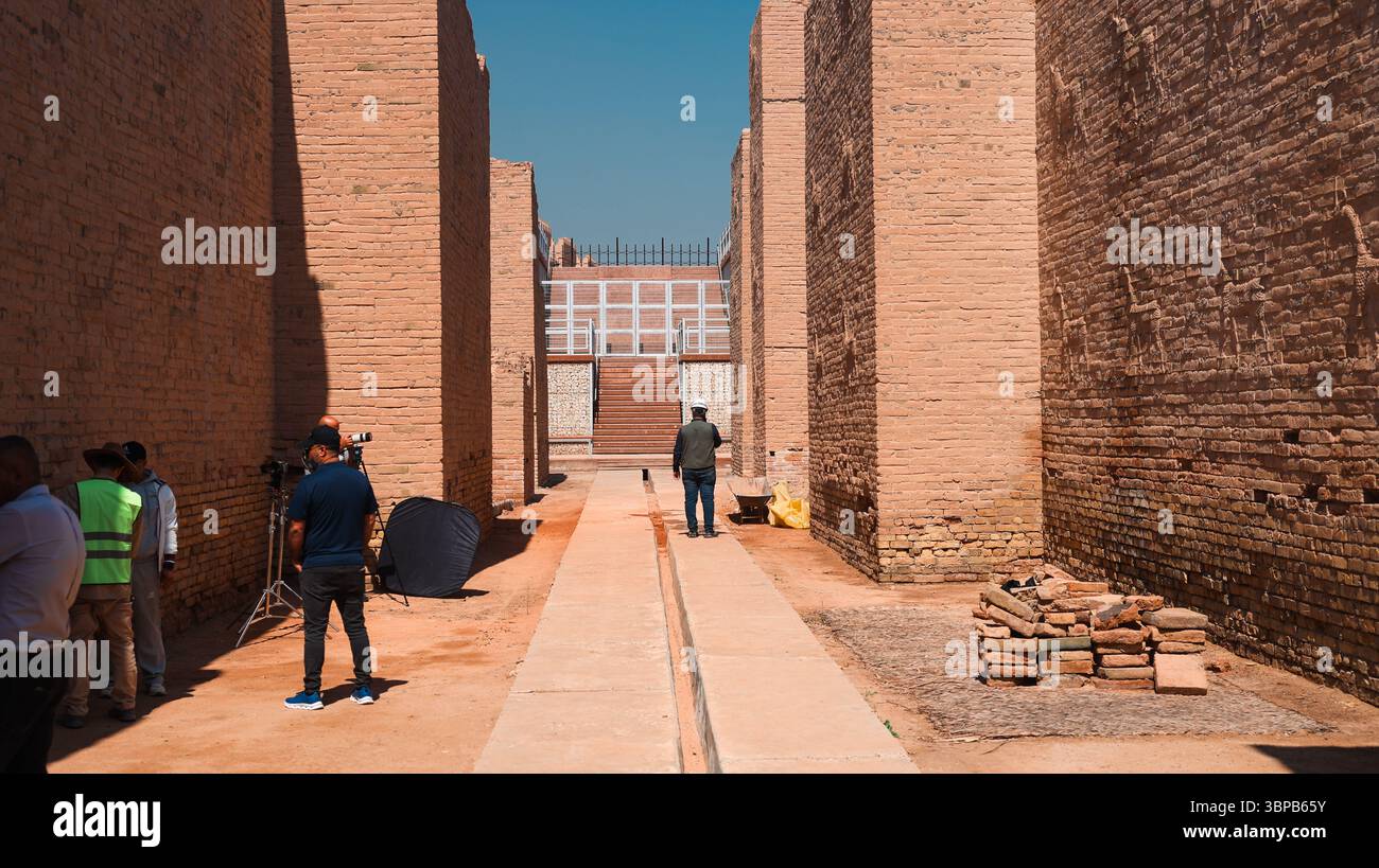 Workers restore ancient structures in Babylon, Iraq, showcasing the ...