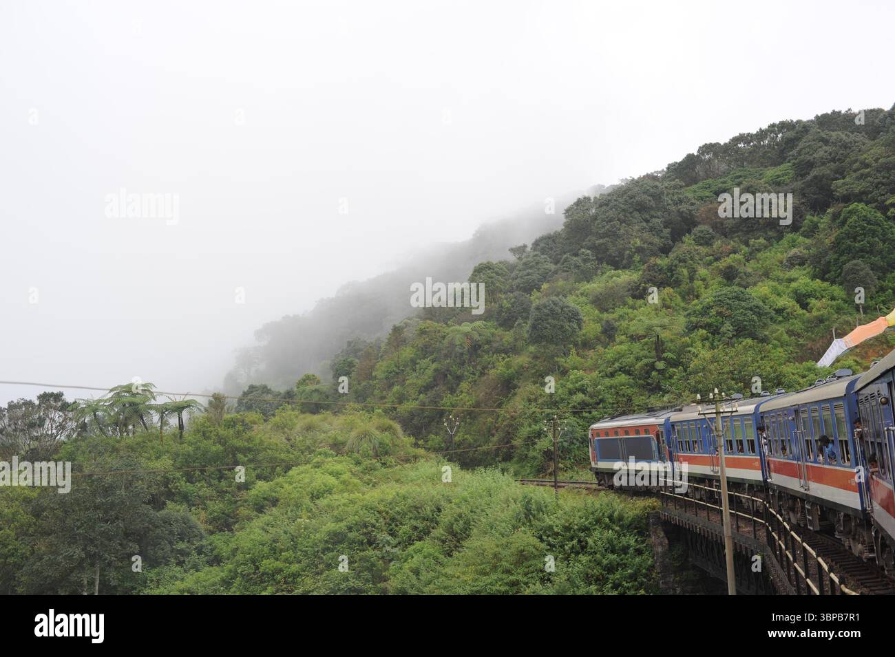 Passenger train with diesel locomotive and blue carriages on the ...
