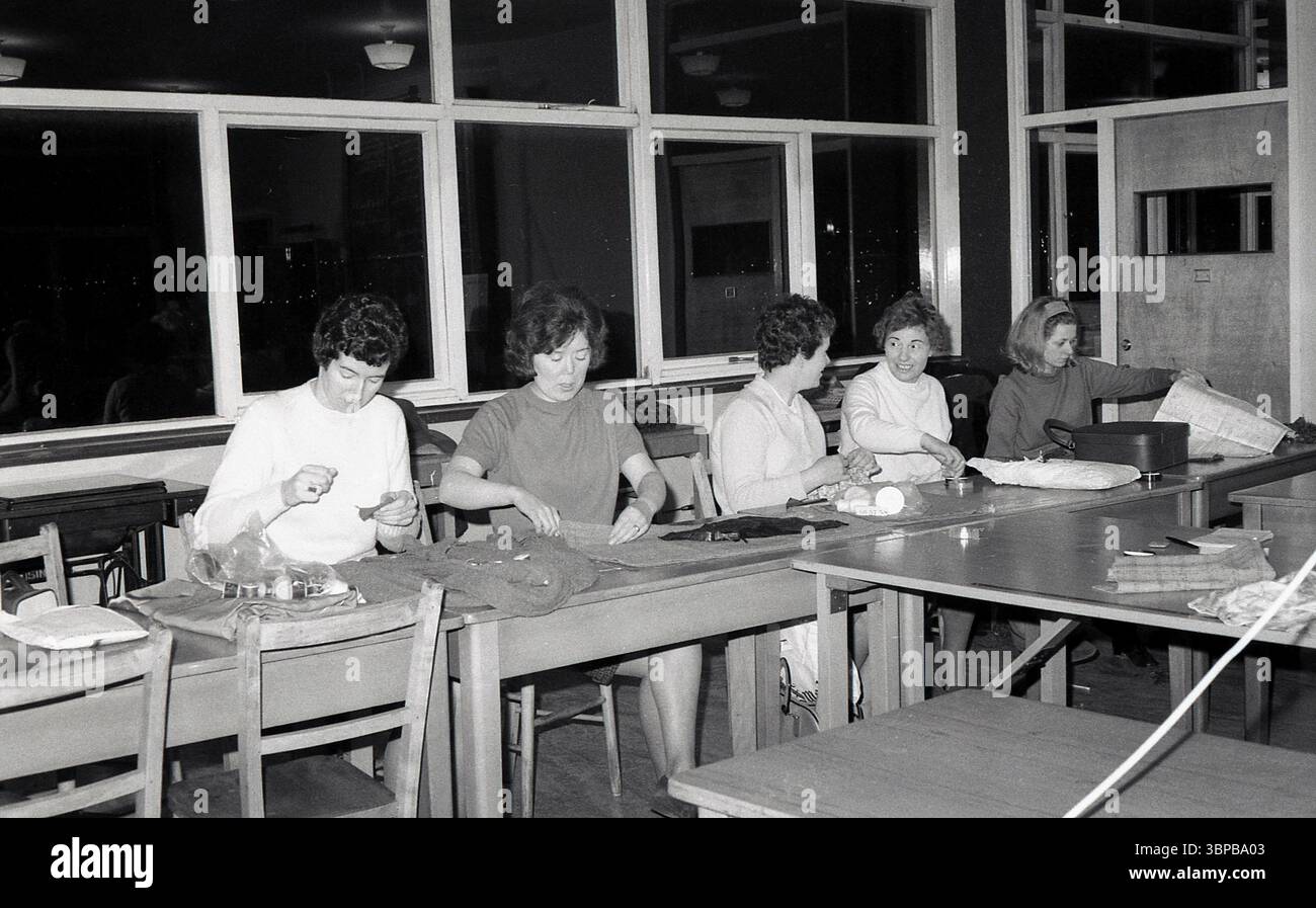 1960s, historical, adult education, inside a school classroom, at desks ...
