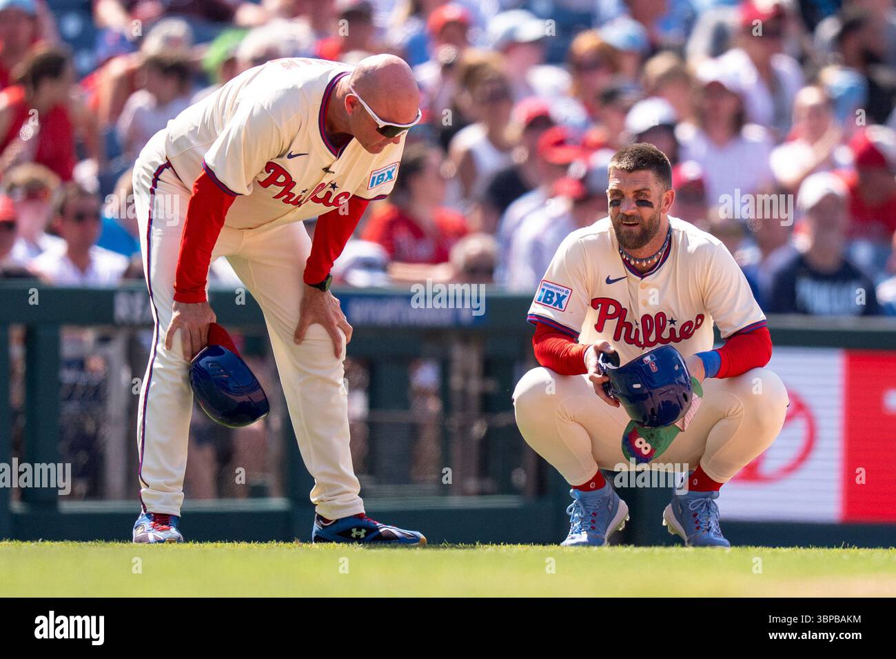 Philadelphia Phillies' Bryce Harper, right, looks on with third base ...