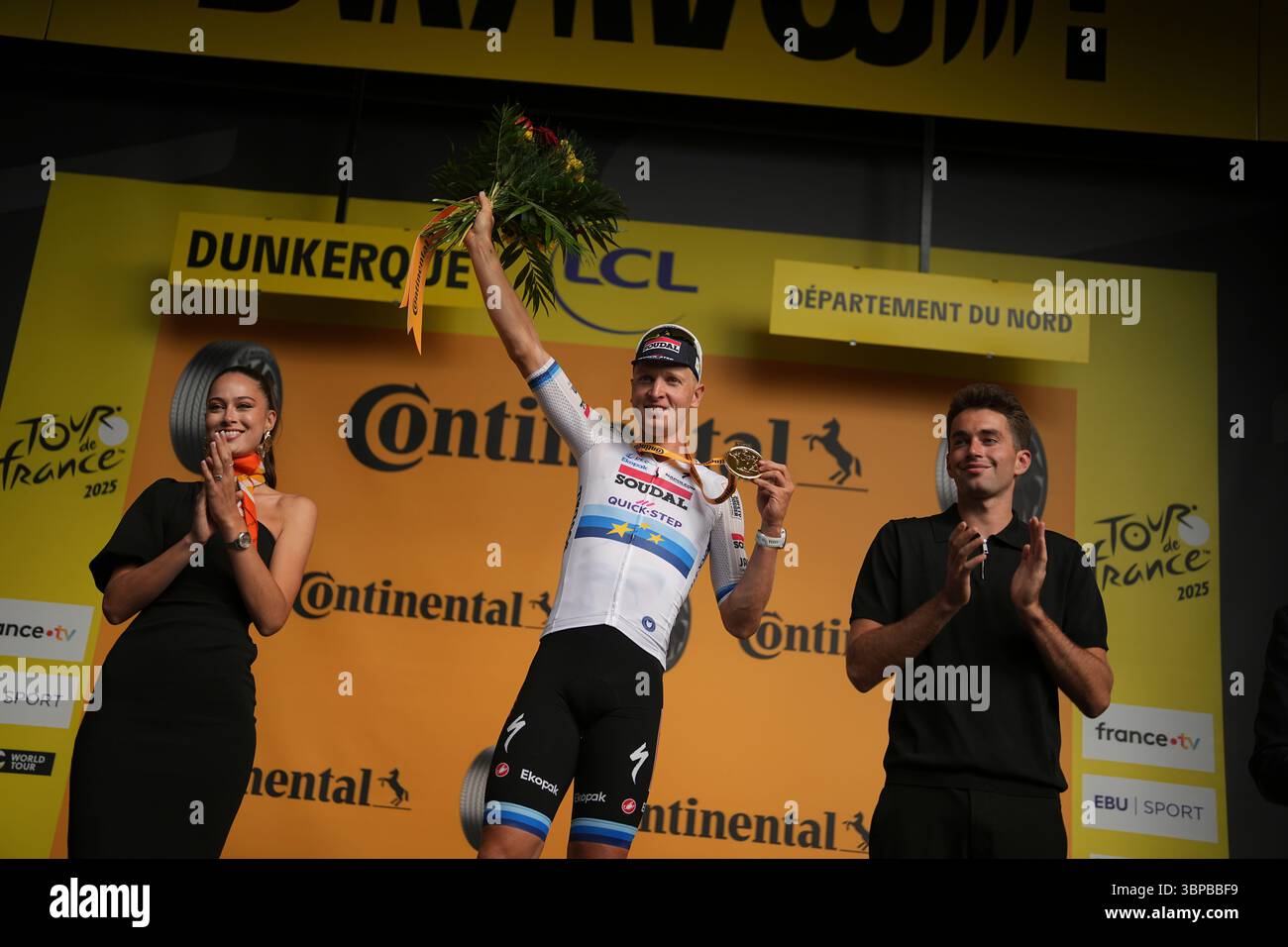 Belgium's Tim Merlier celebrates celebrates on the podium after winning ...