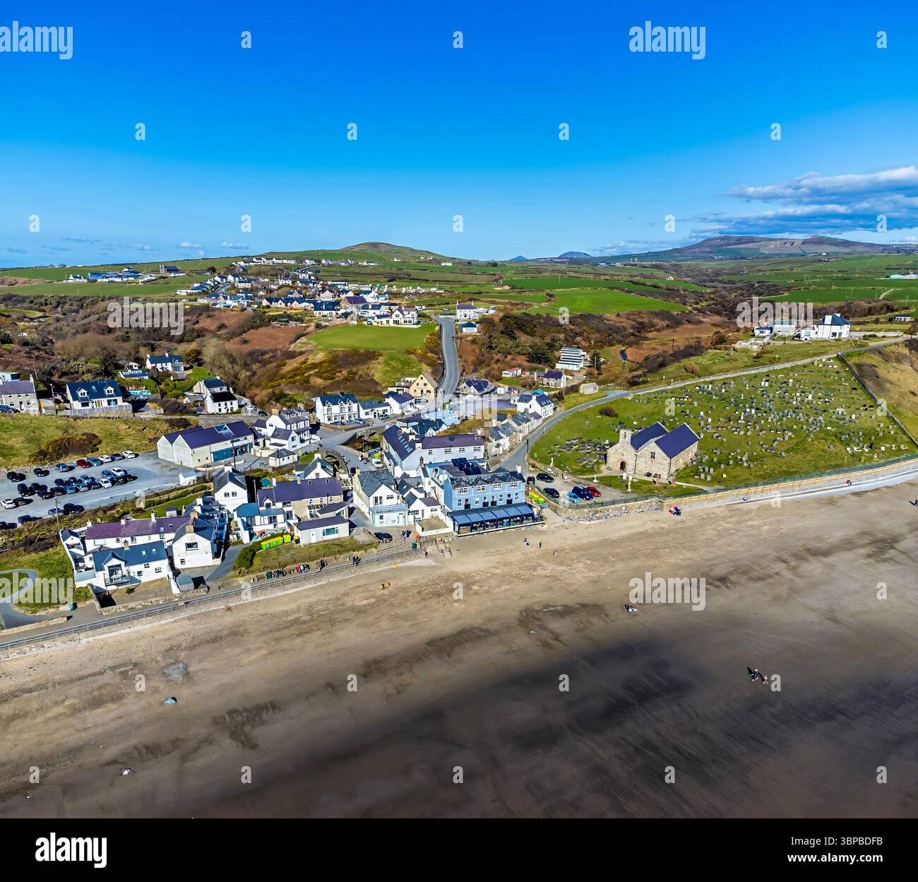 An aerial view above the beach and town of Aberdaron, Wales in ...