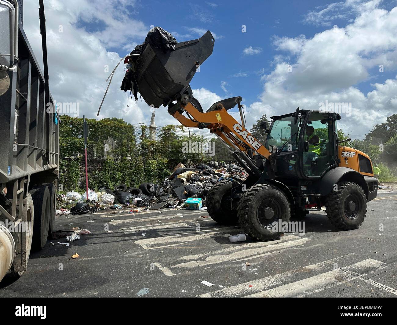 Trash is cleaned up at a drop-off site in Philadelphia as thousands of ...