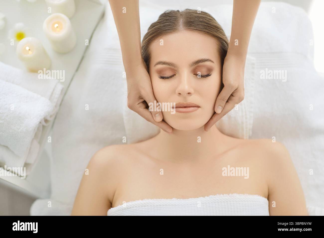 Cosmetologist performing female face, spa massage, skin, wrinkles ...
