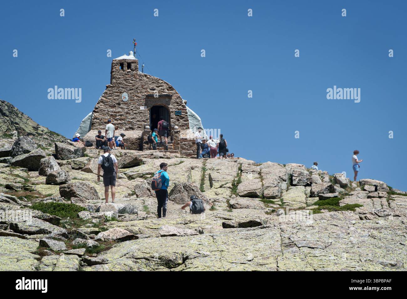 A group of people are walking up a hill. There are several people in ...