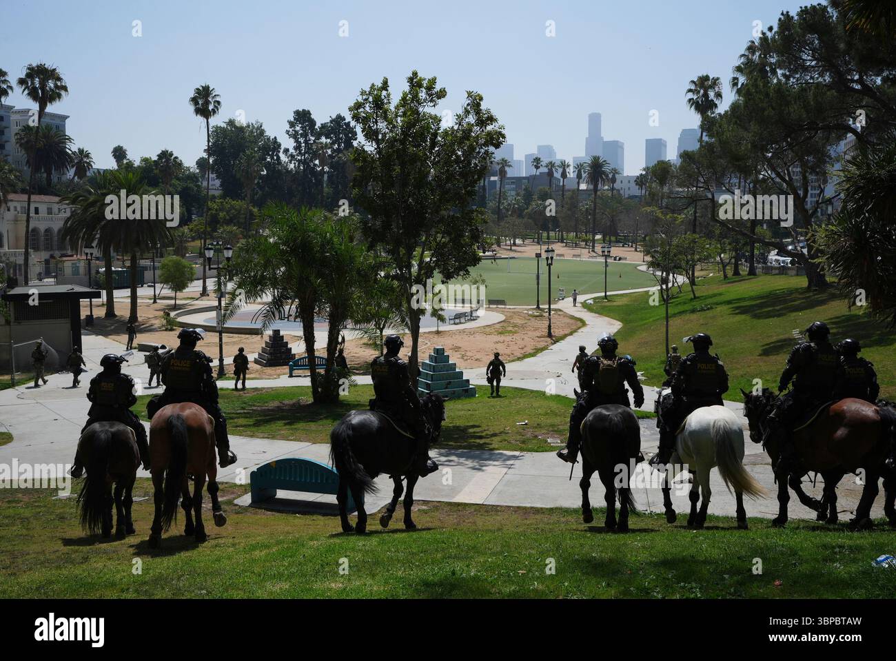 Federal agents ride on horseback at MacArthur Park Monday, July 7, 2025 ...