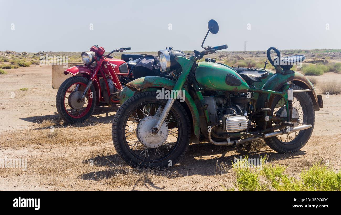 Two old style motorbike parked in a desert style field Stock Photo - Alamy