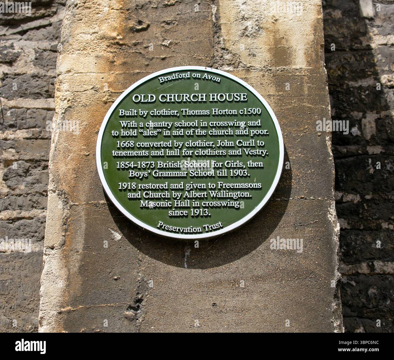 Historic plaque on stone wall showing the history of Old Church House ...