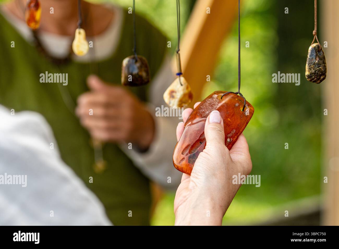Amber necklaces hanging. Amber of different colors and sizes ...