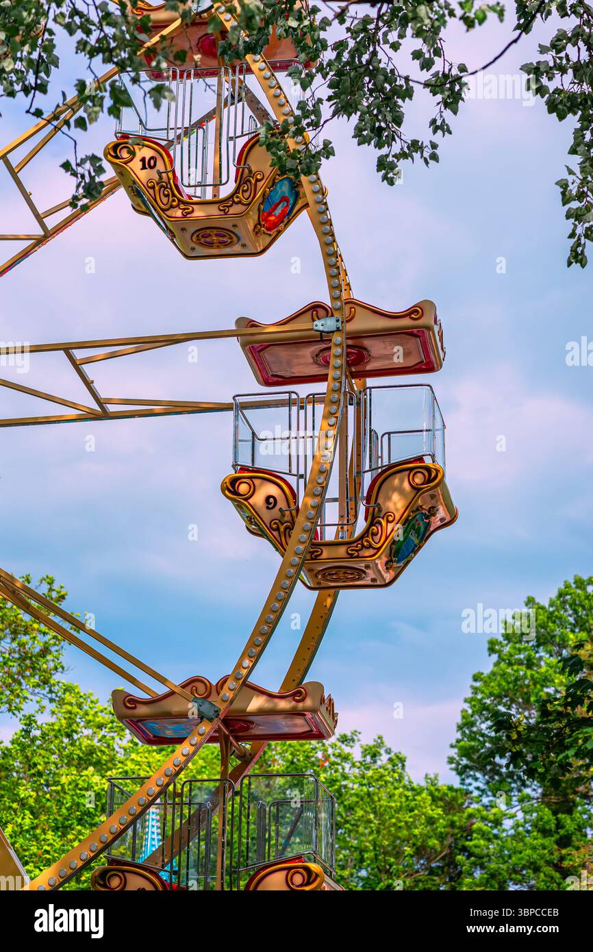 Colorful Ferris wheel detail with vintage style gondolas framed by ...