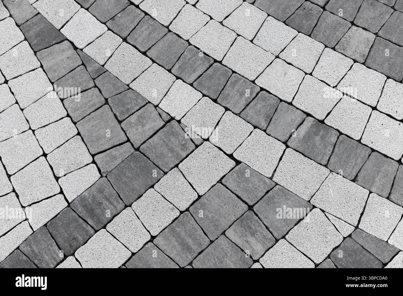 Geometric pavement design with alternating dark and light tiles in a ...