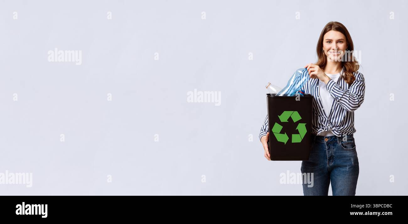 Millennial woman promoting eco-friendly recycling habits with a smile ...