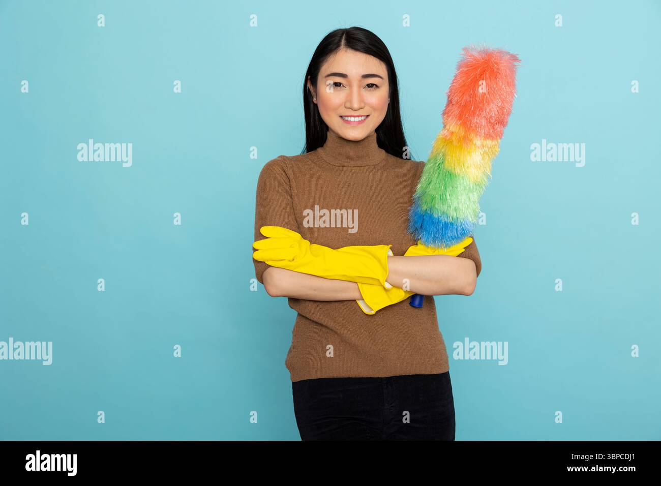 Happy young asian housekeeper wearing yellow rubber gloves, smiling ...