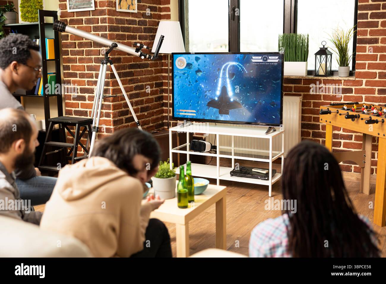 Multicultural group enjoying online shooter game tournament at house ...