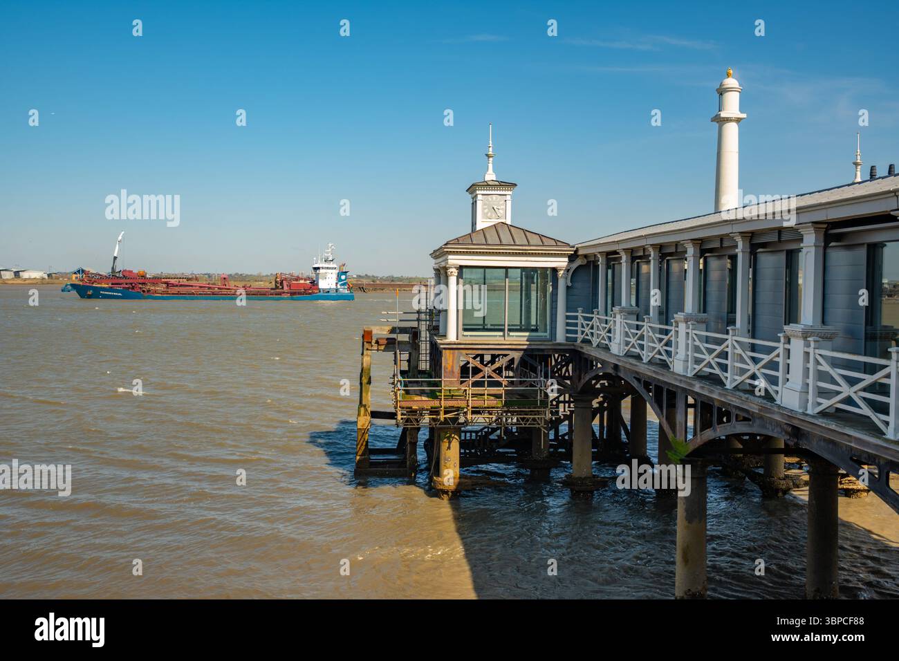 Boat sailing up stream passing the Town Pier Gravesend Kent Stock Photo ...