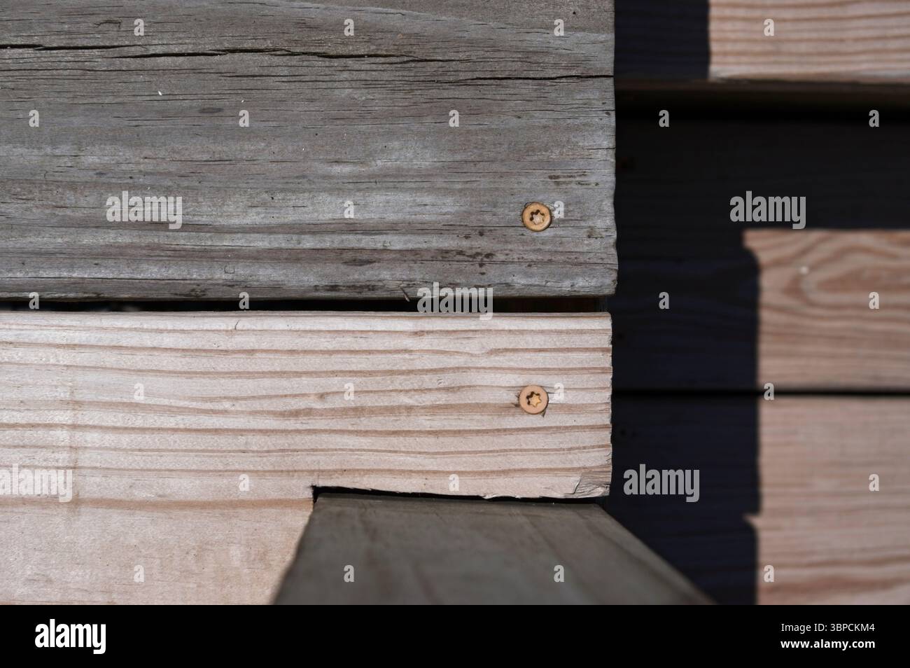 Screws holding down wood deck boards Stock Photo - Alamy