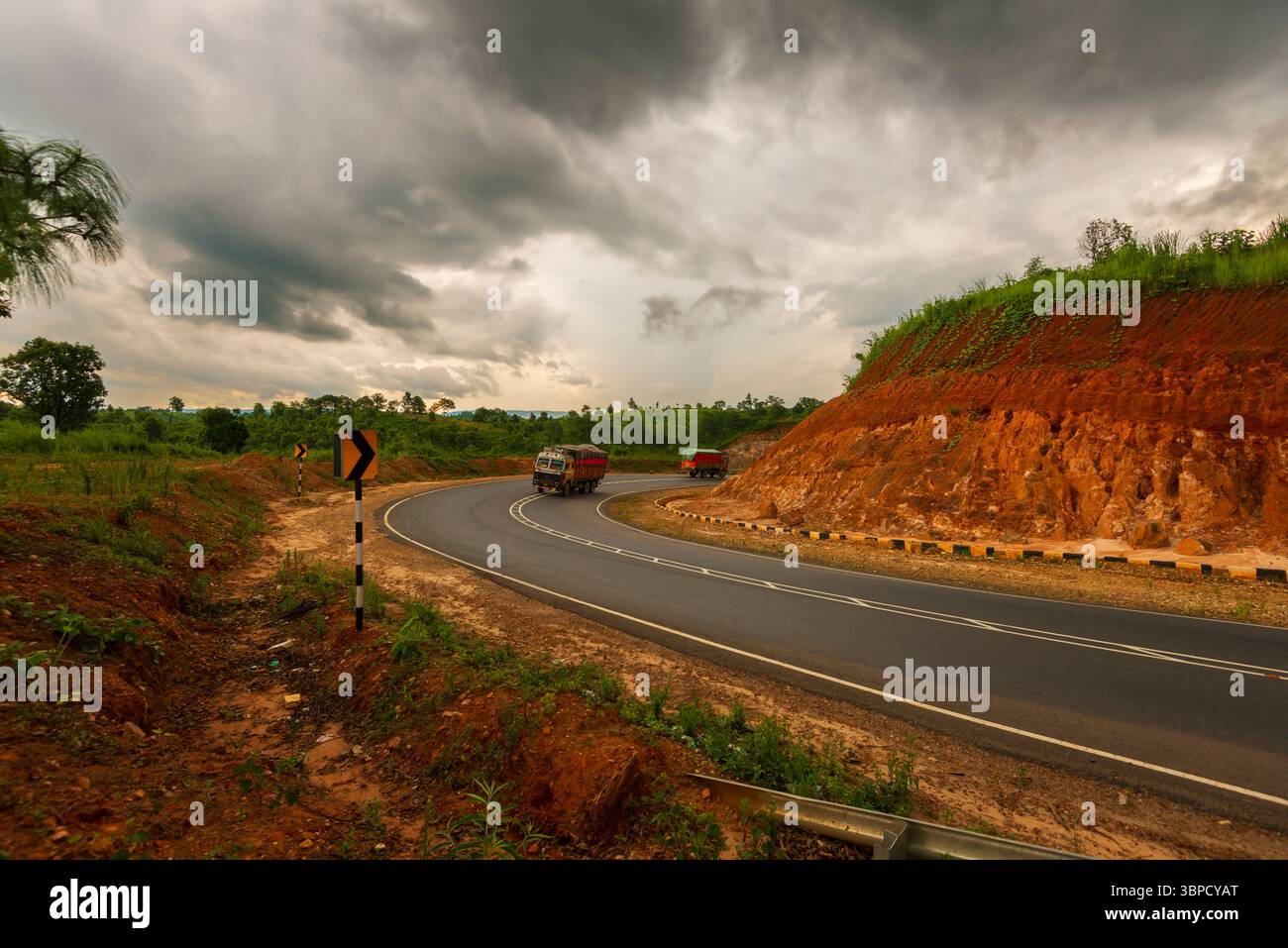 Thick monsoon clouds covers the landscape as Tata trucks slowly climbs ...