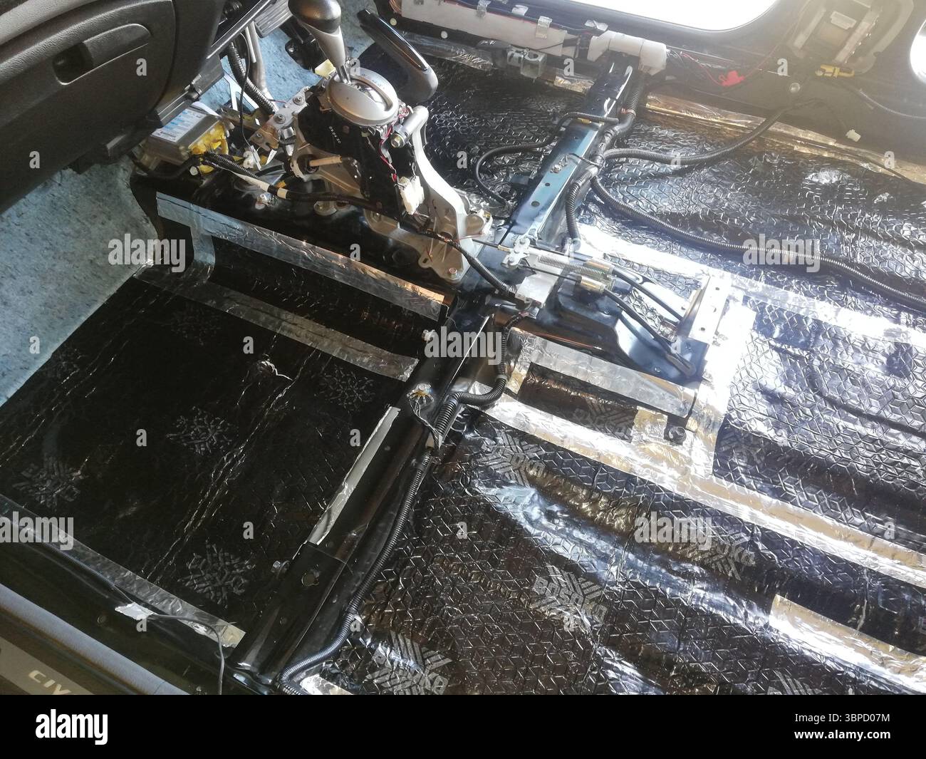 Car soundproofing installation using butyl sheets, foam, and acoustic ...