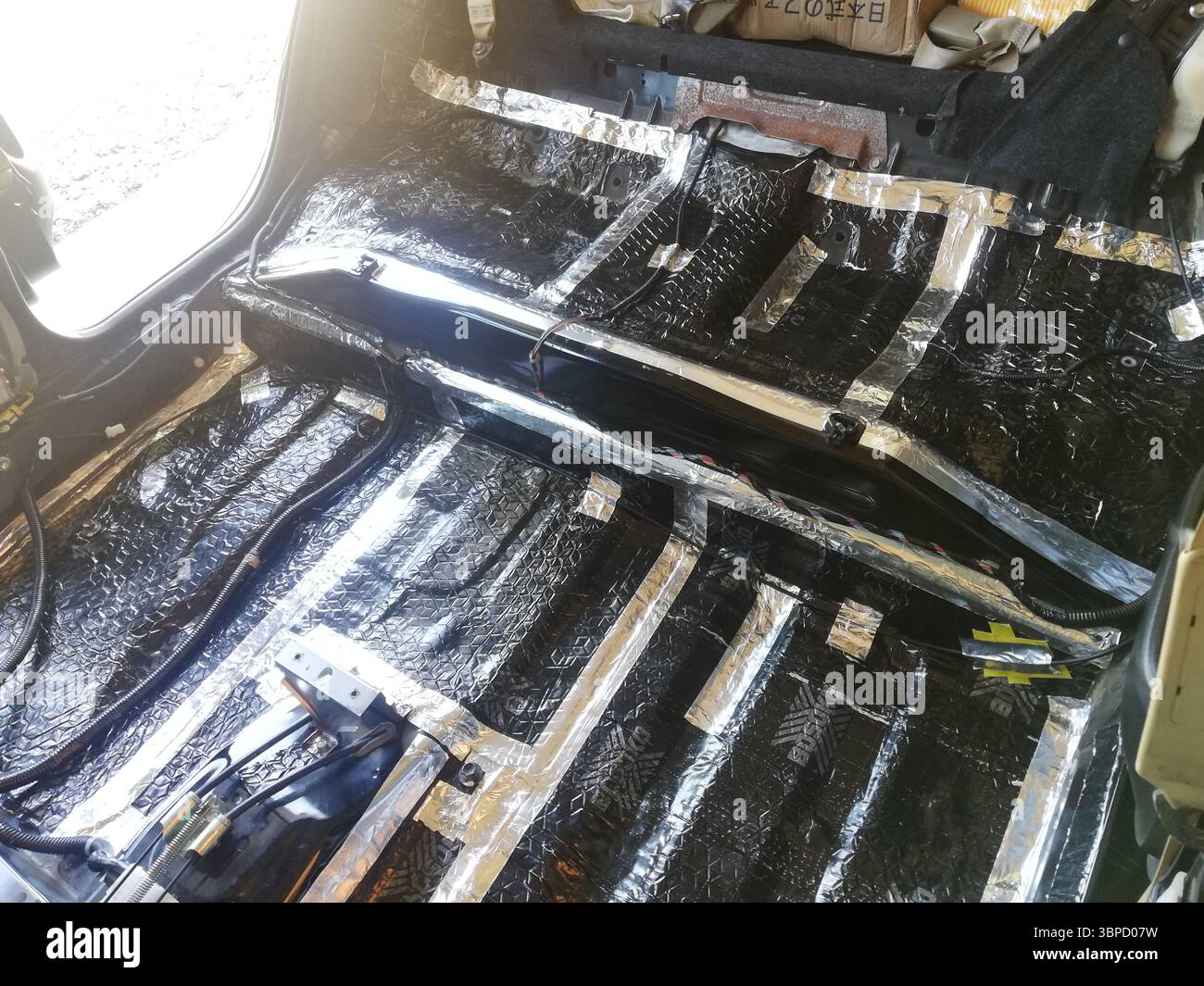 Car soundproofing installation using butyl sheets, foam, and acoustic ...