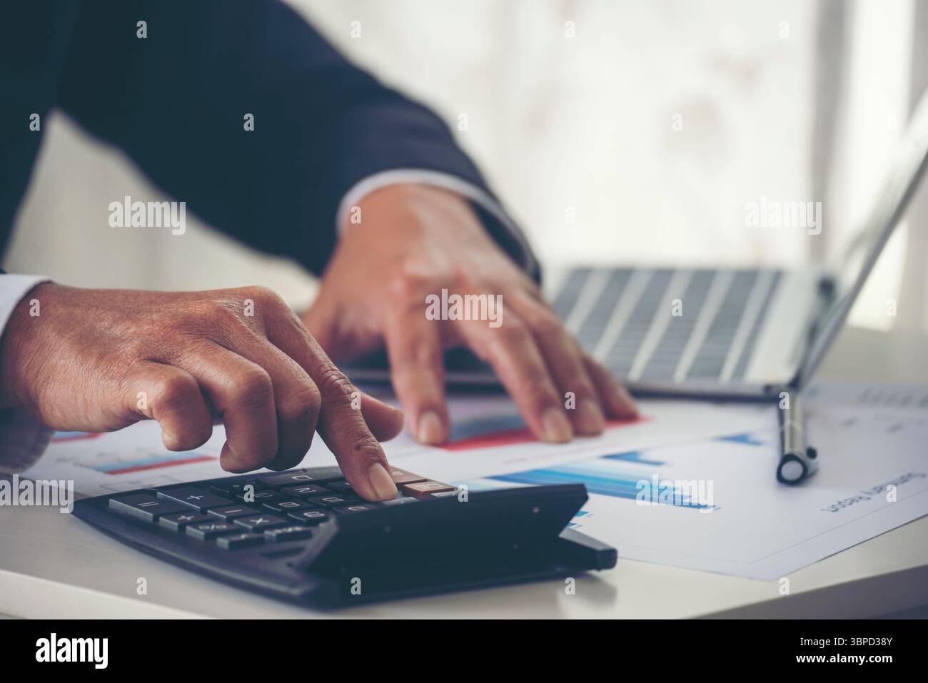 Close up business man hands using calculator counting tax financial ...