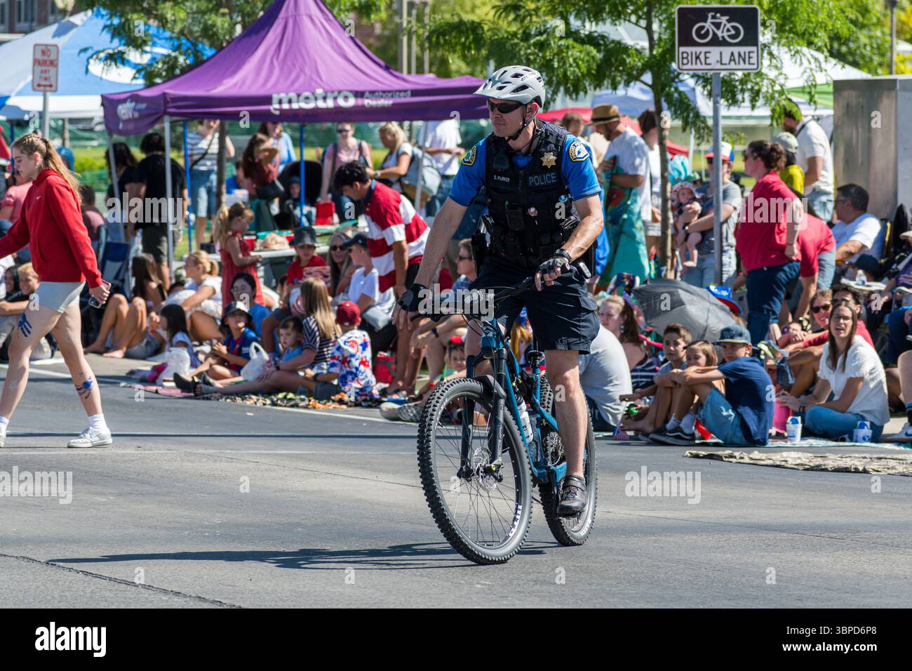 Provo, UT – July 4, 2025: A police officer rides a bicycle along the ...