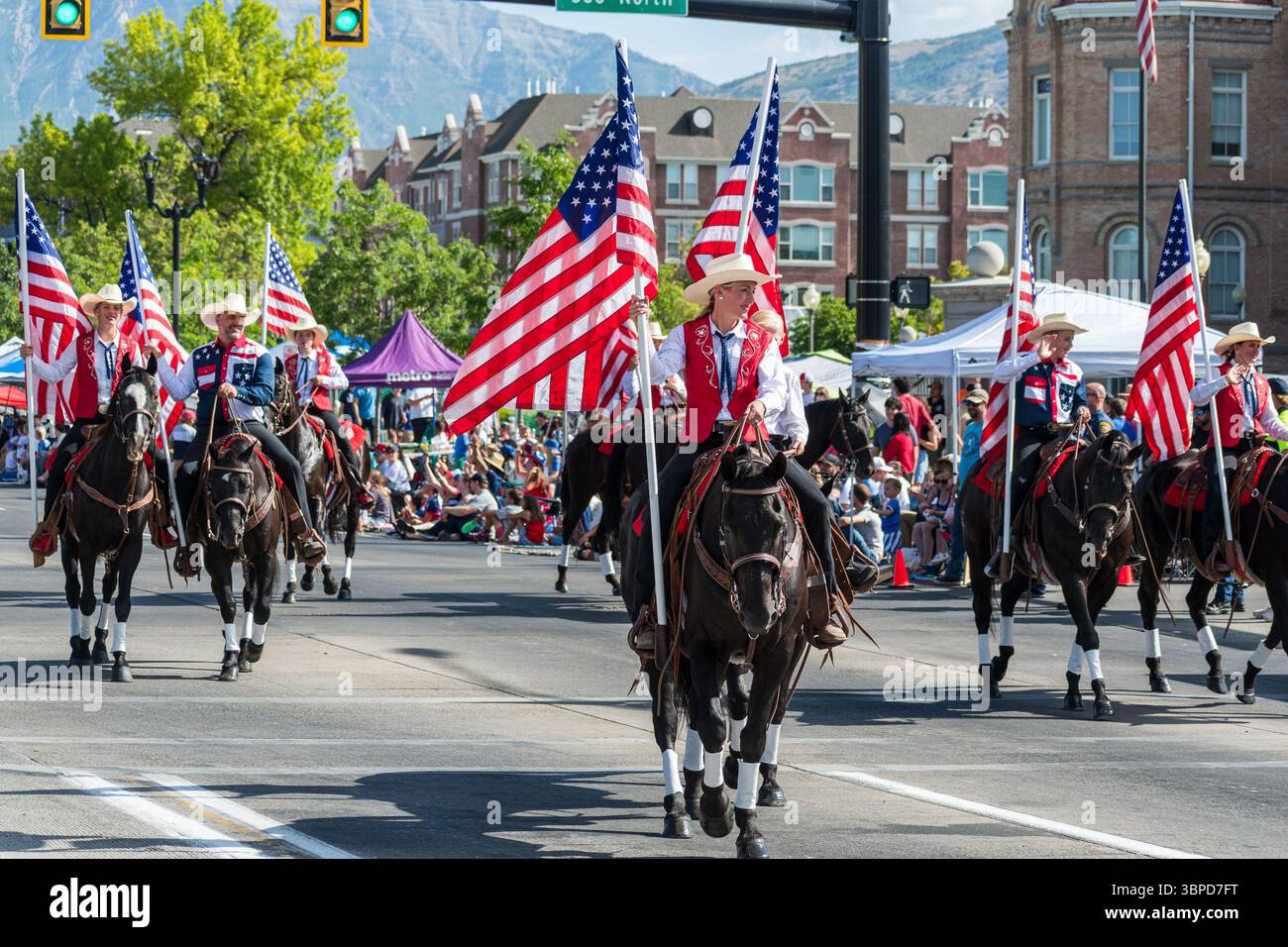 Provo, Utah – July 4, 2025: Riders from a Western equestrian team carry ...