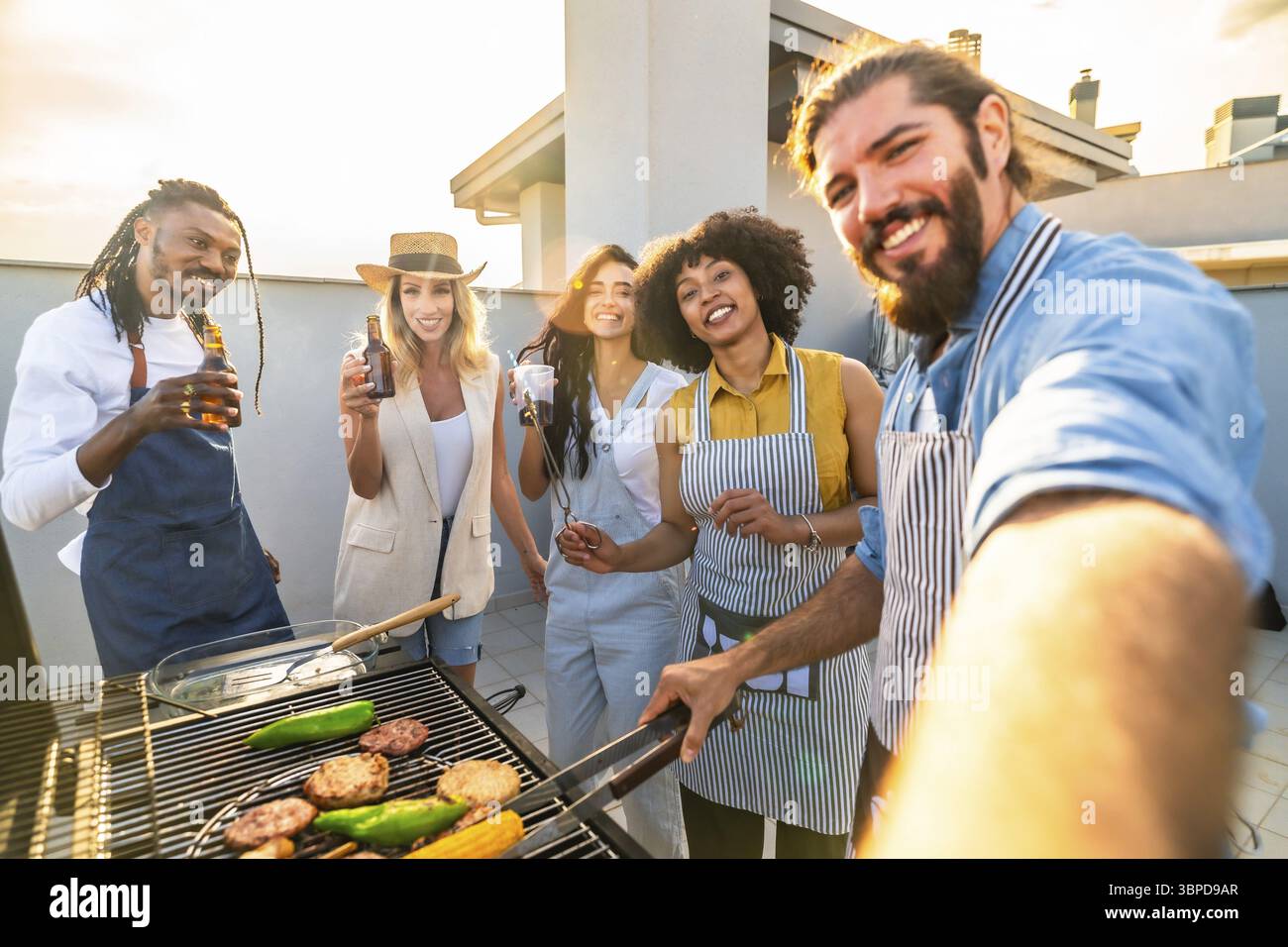 Cheerful friends enjoying rooftop barbecue hi-res stock photography and ...