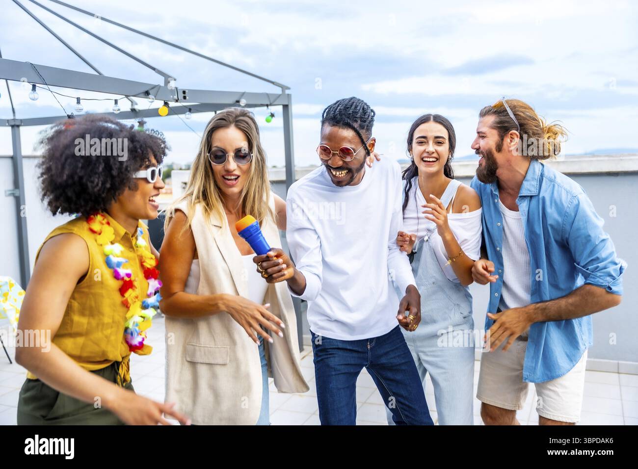 Friends dancing singing rooftop party hi-res stock photography and ...