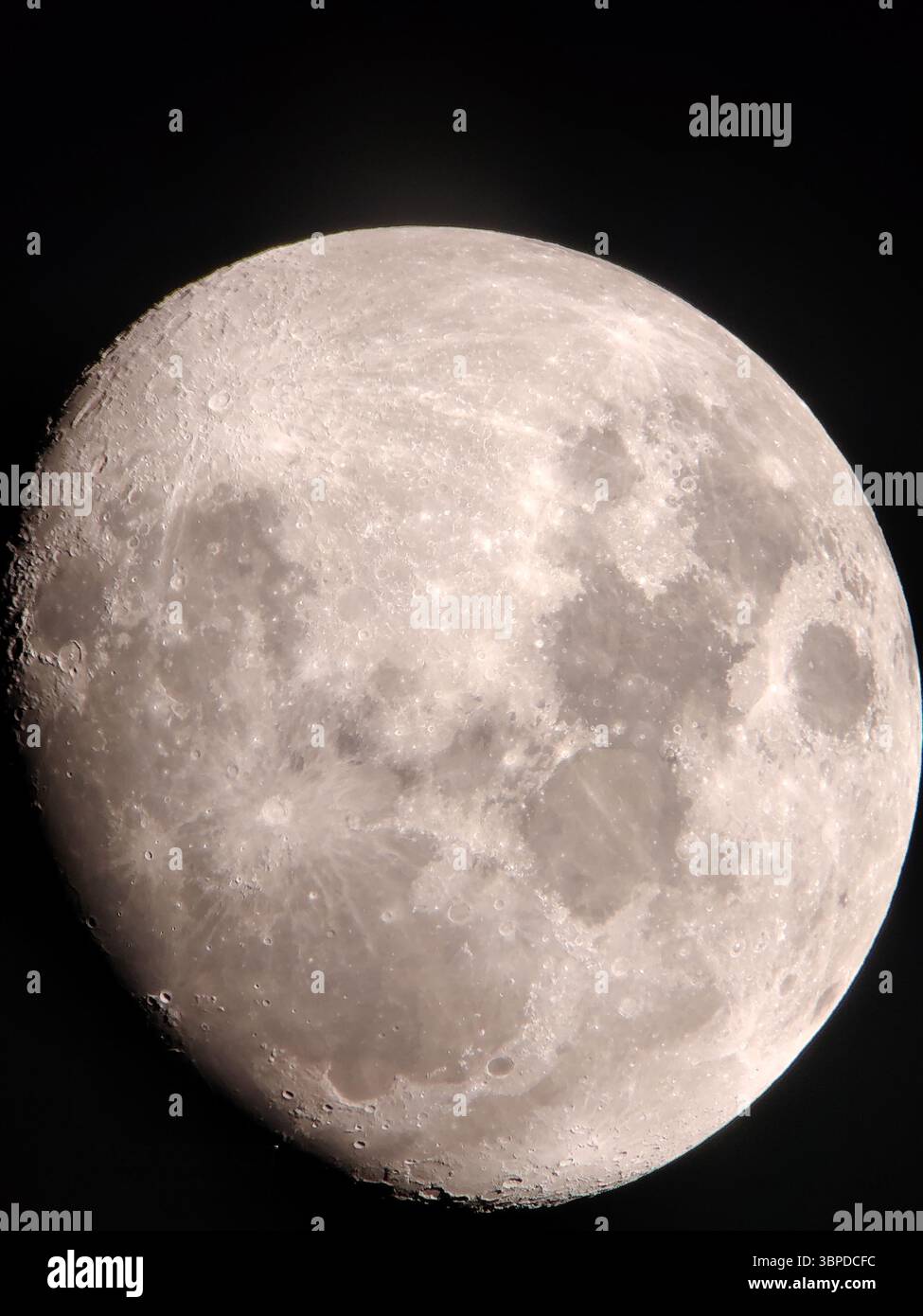 A highresolution picture of the bright waxing moon shines in the dark ...