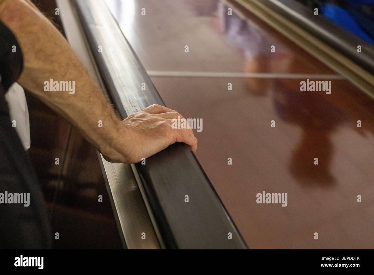 elderly man hand holding railing on escalator in subway Stock Photo - Alamy