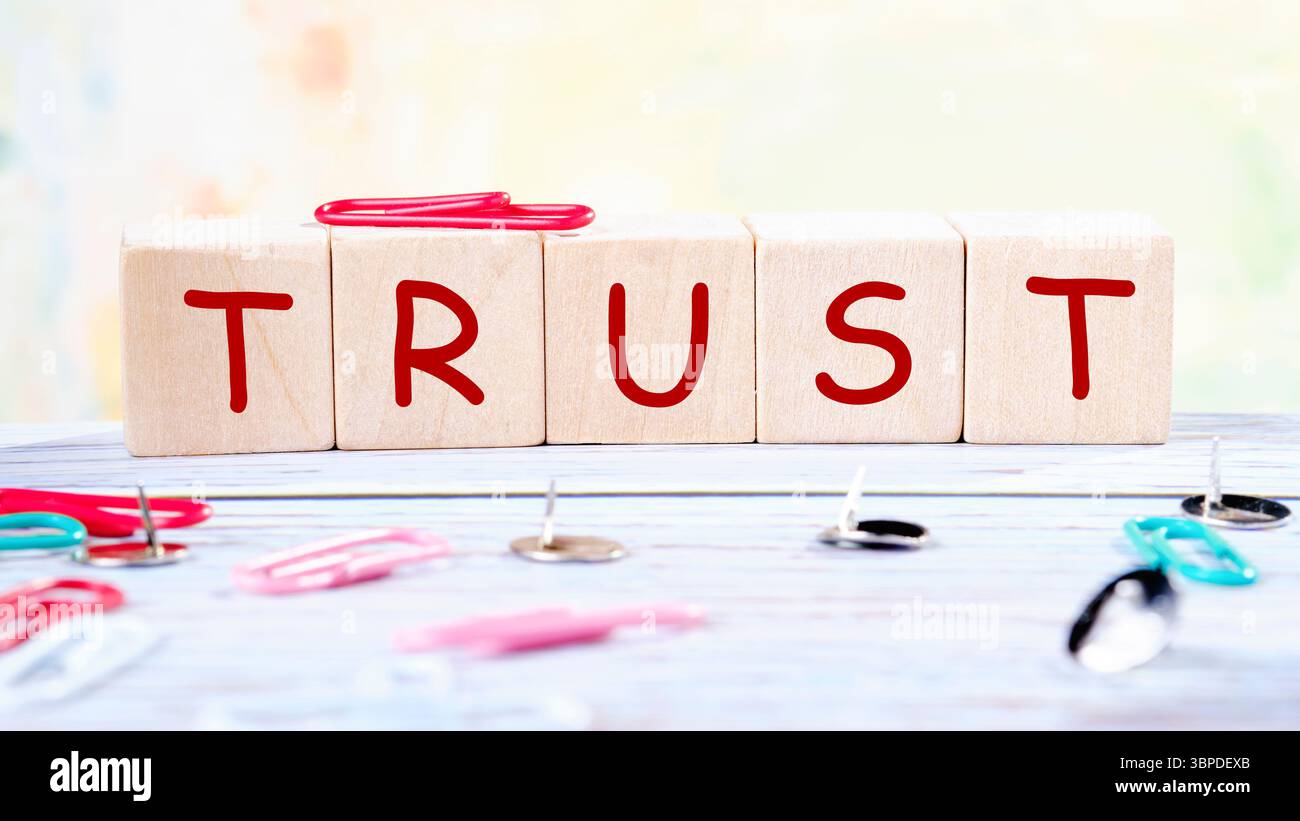 The concept word TRUST is assembled from wooden cubes. Investment based ...