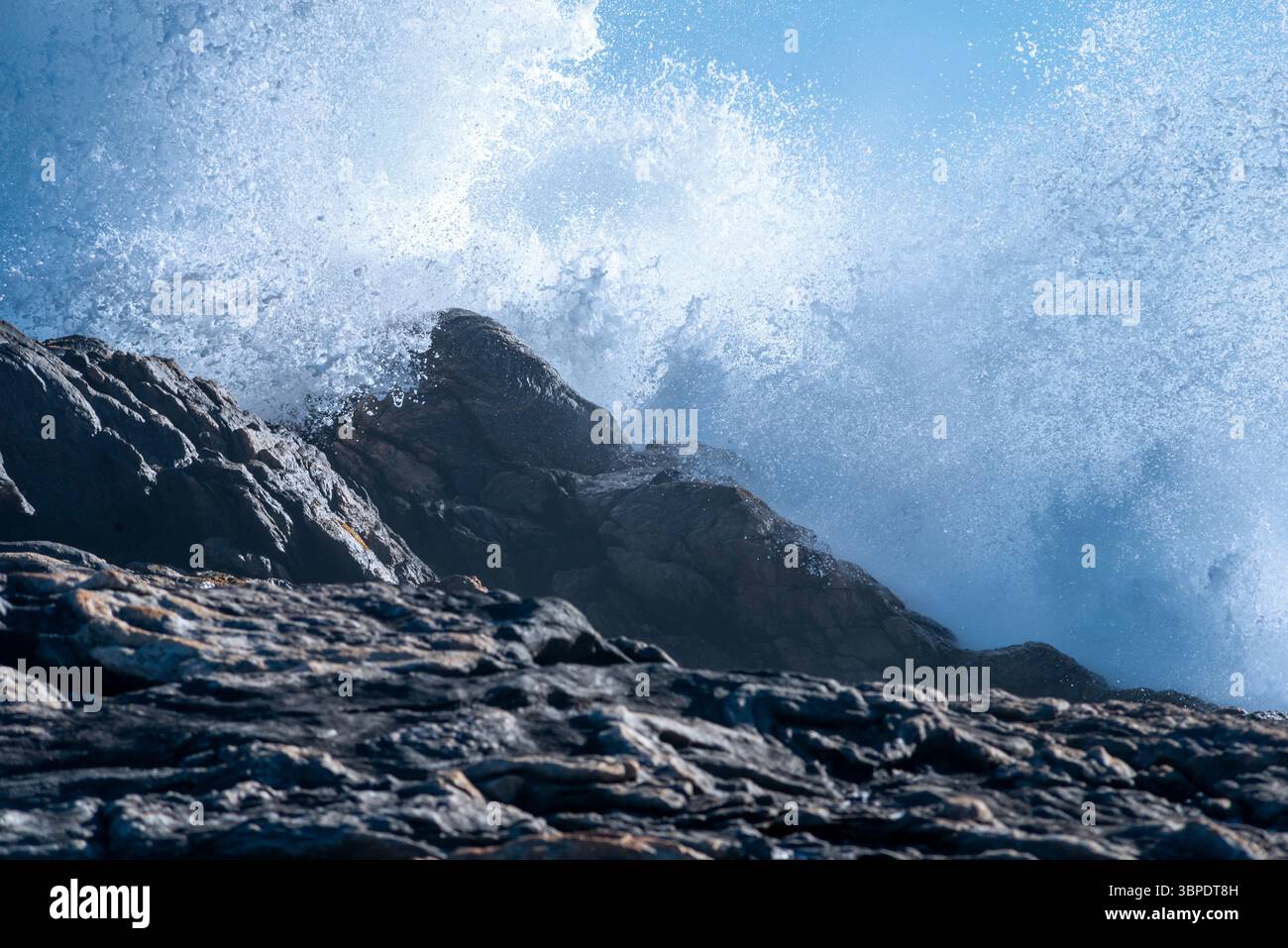 breaking surf wave on the rocky shore of the Atlantic Ocean in Namibia ...