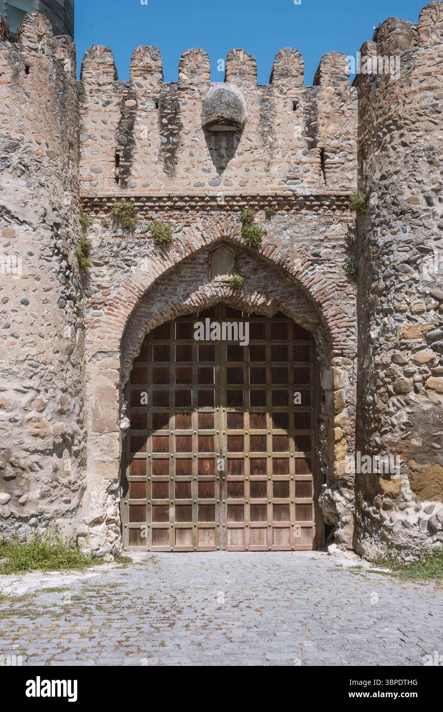 closed gate and massive fortress wall of famous Svetitskhoveli ...