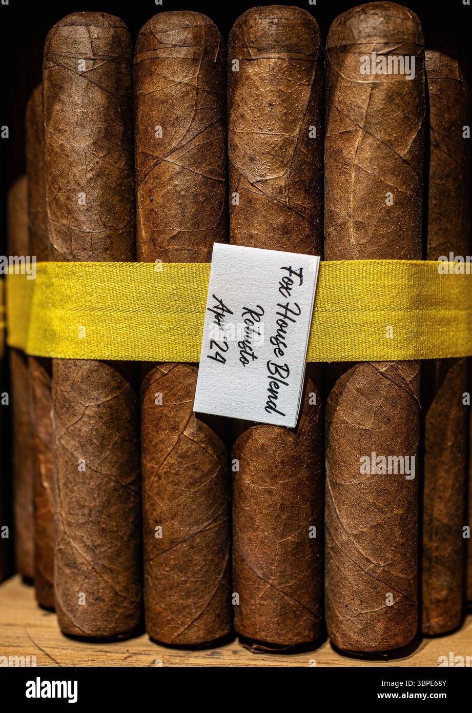 Bundles of cigars in the humidor room with constant humidity and ...
