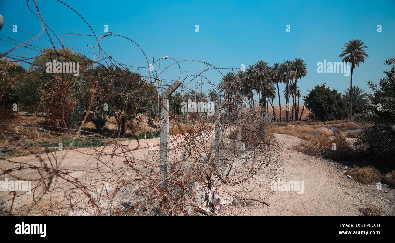 A barbed wire fence encloses the premises of Saddam Hussein Palace in ...