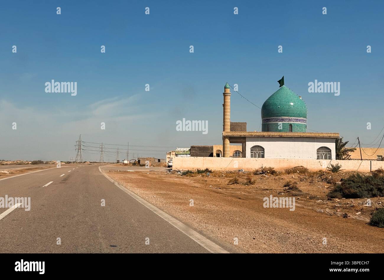 A serene rural landscape featuring a historic mosque with a green dome ...
