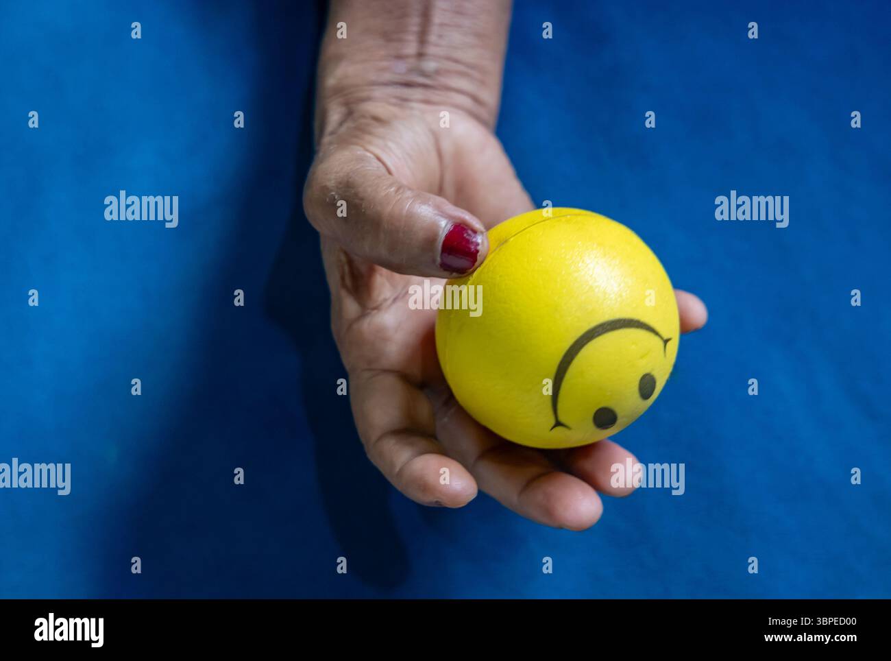 rehabilitation grip training using smiley ball in hand Stock Photo - Alamy