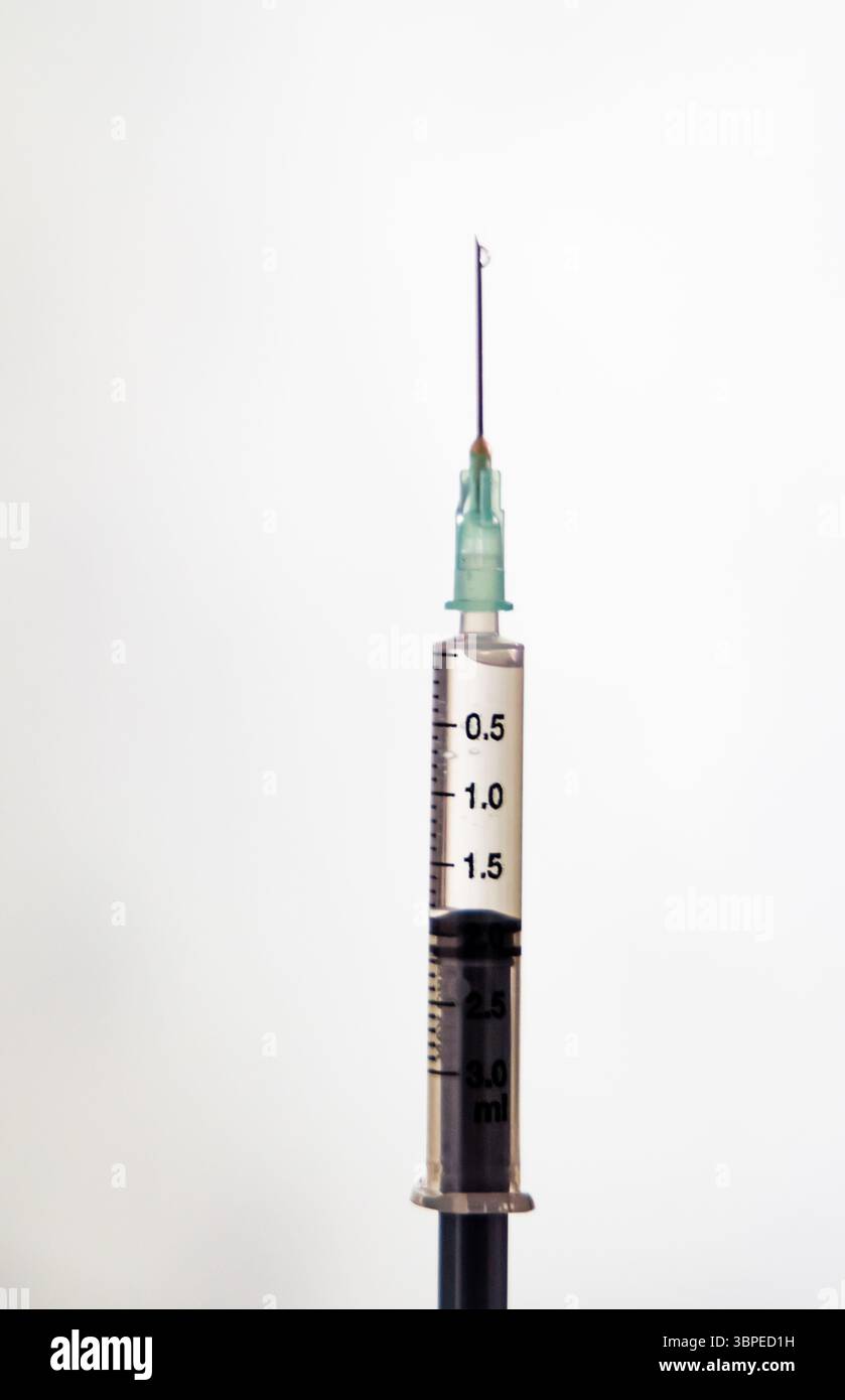 medical injection filled with drug ready to use under bright light ...